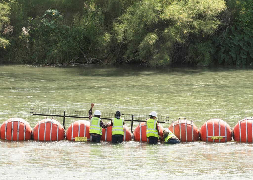 Biden administration sues Texas over anti-migrant buoys in the Rio Grande