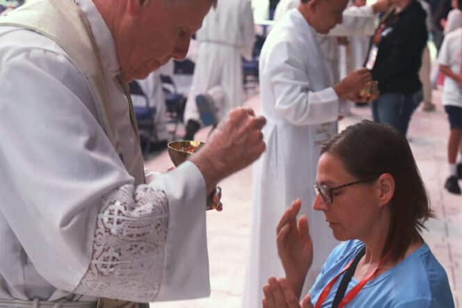Is kneeling to receive holy Communion during Mass allowed?