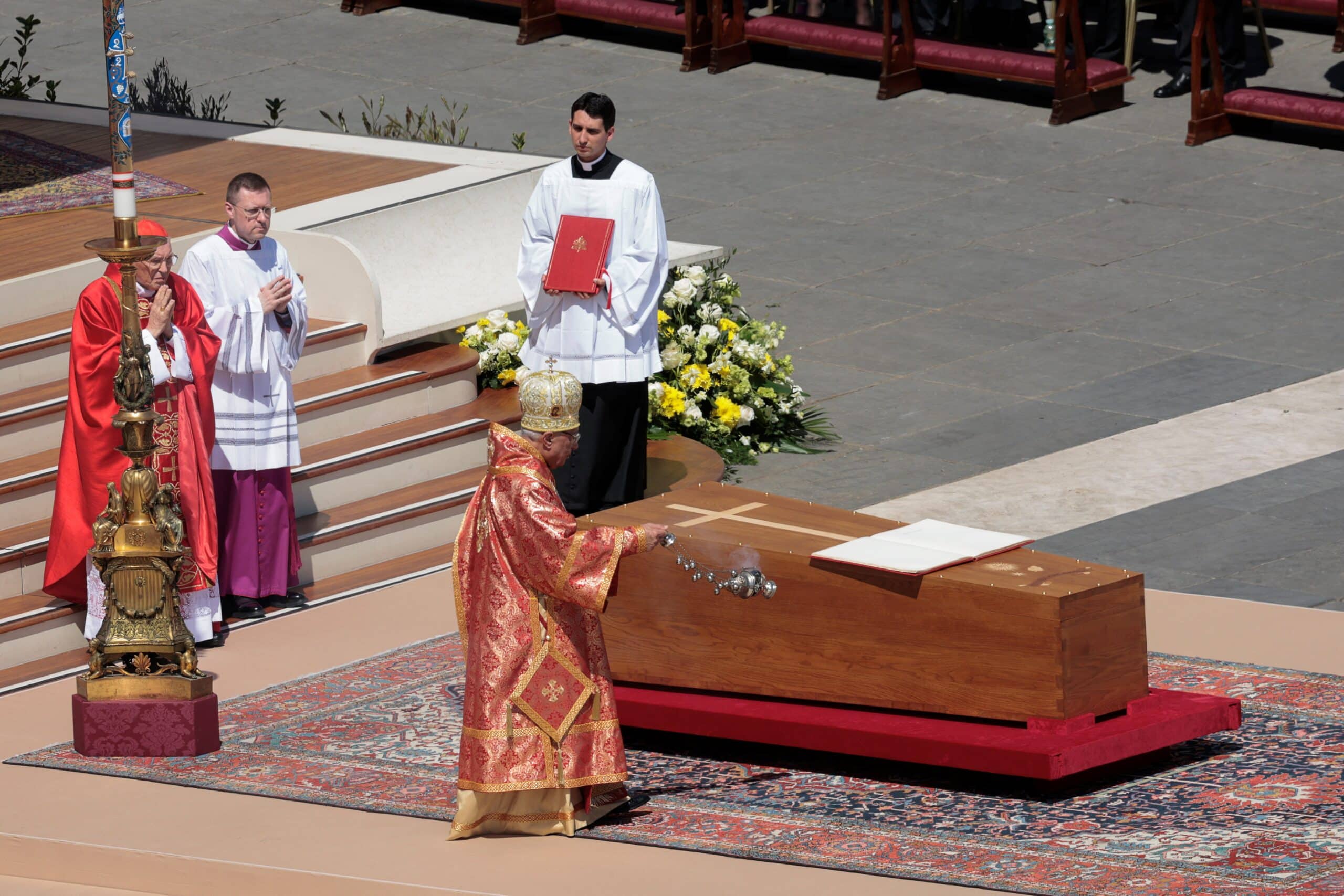 Poor and powerful pray for eternal repose of a pope at funeral
