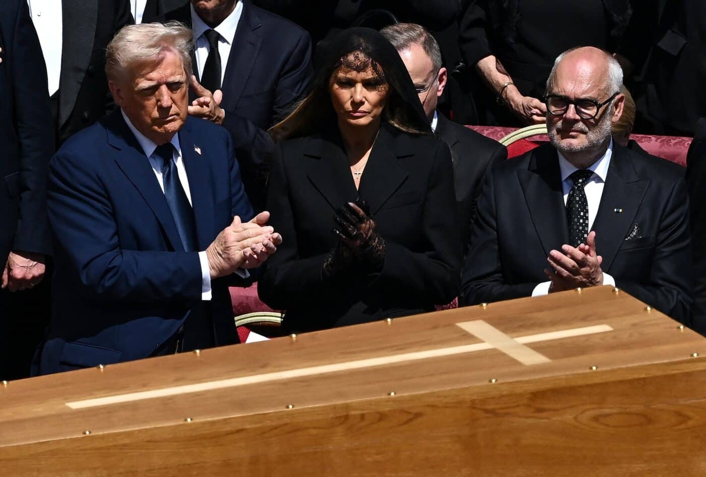 Poor and powerful pray for eternal repose of a pope at funeral